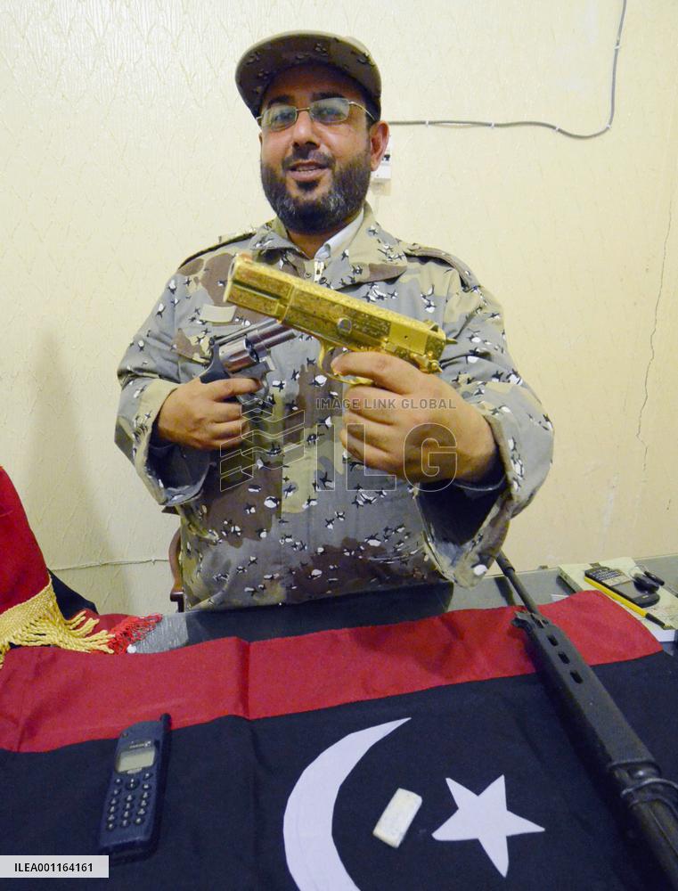 Gaddafi's pistol, satellite phone | Imagelinkglobal ILG: Product ...